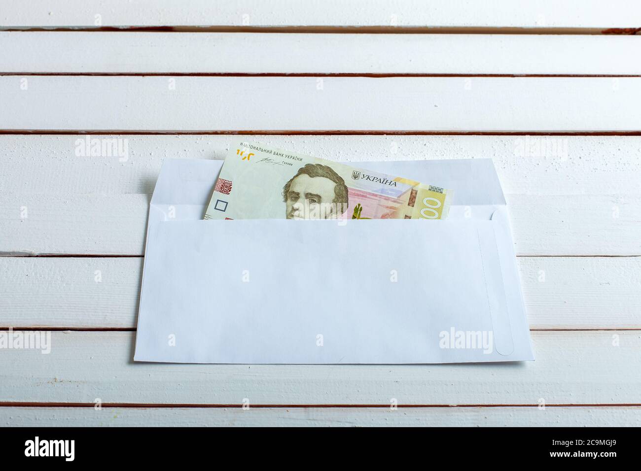 Cash in an envelope, the denomination of ukrainian hryvnia on a table ...
