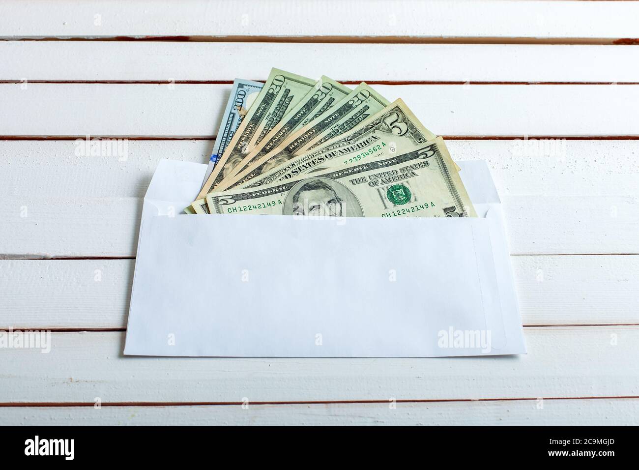 Cash in an envelope, the denomination on a table from white wooden ...