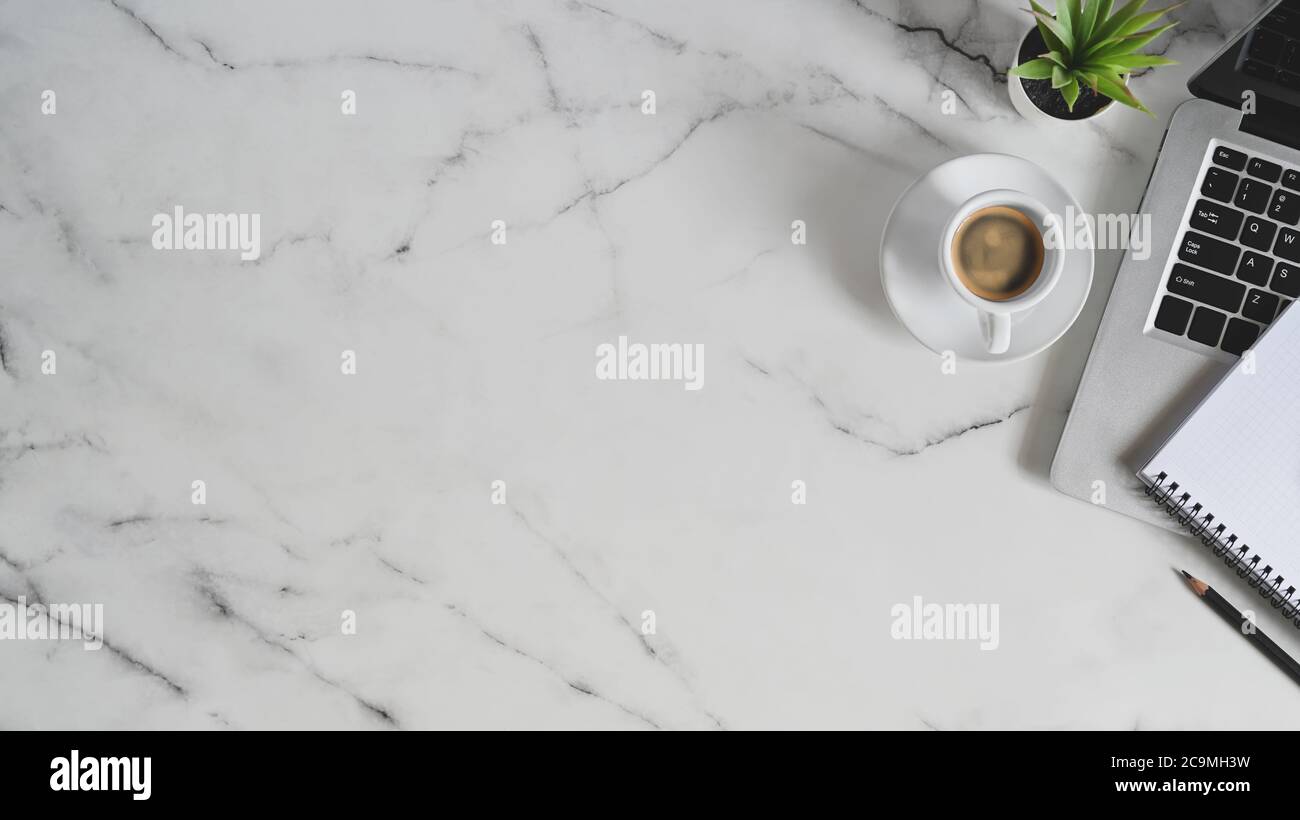 Top view marble texture workspace is surrounding by a laptop and ...