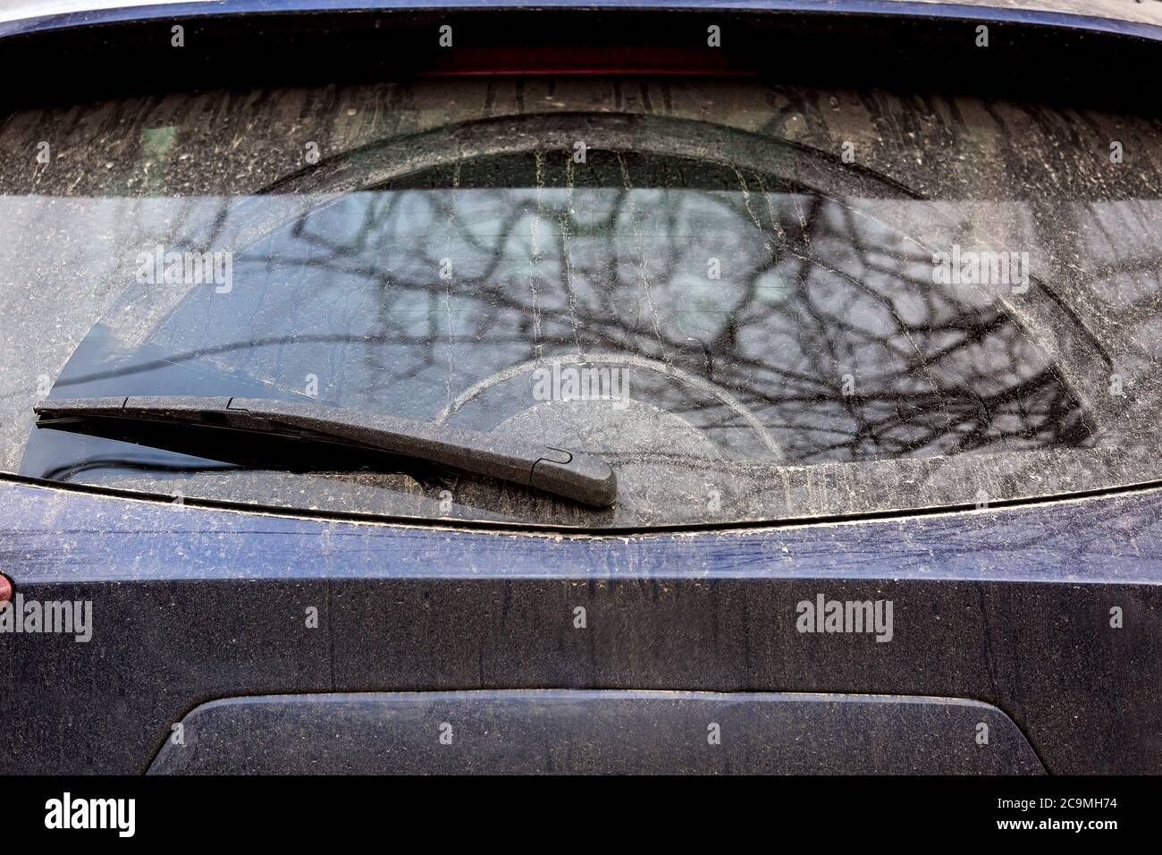 rear window of a crossover with a car wiper in a layer of dry mud in ...