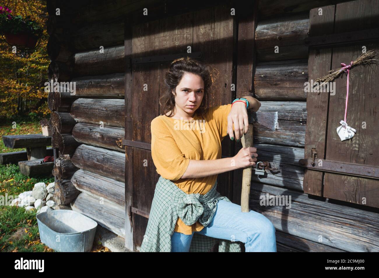 girl with an ax near a wooden house in the mountains Stock Photo - Alamy