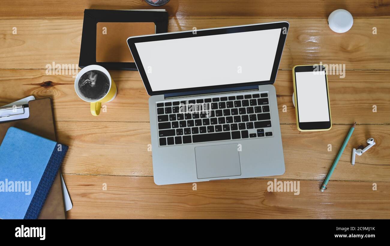 Top view office desk is surrounding by a white blank screen computer ...
