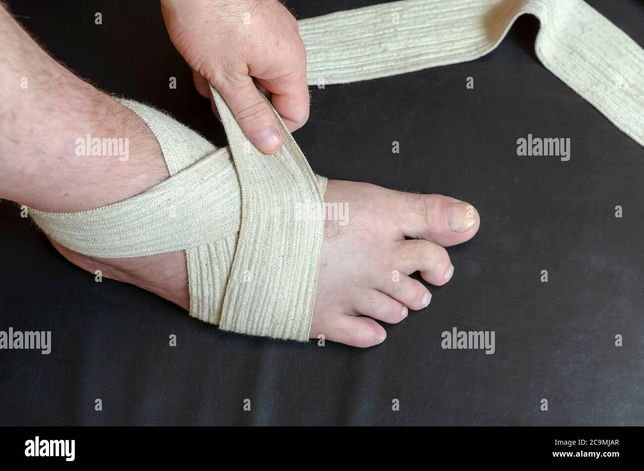 Middle-aged Caucasian man produces an independent bandage of his ...