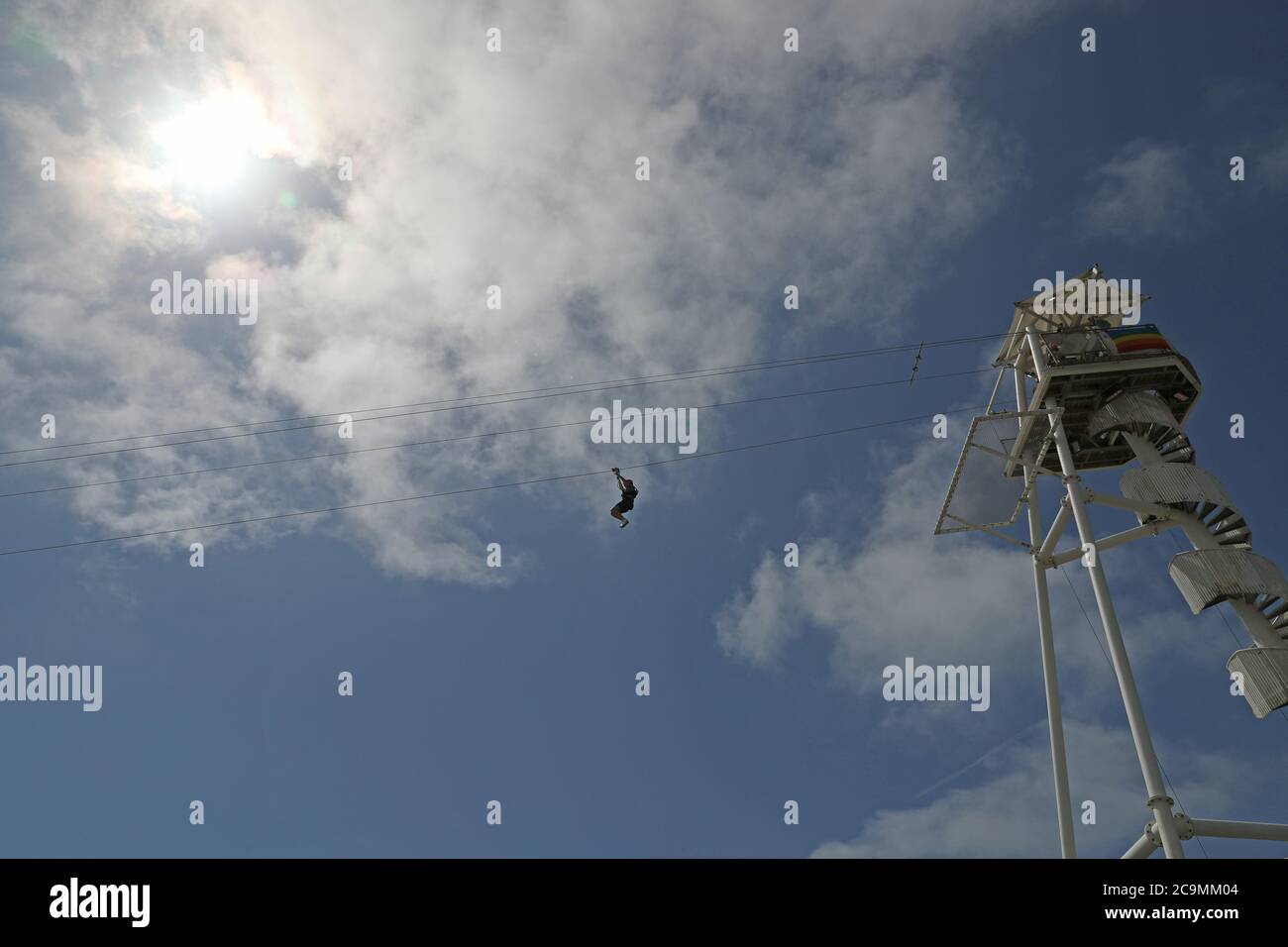 A person uses a zip line as people the hot weather on Brighton beach in ...