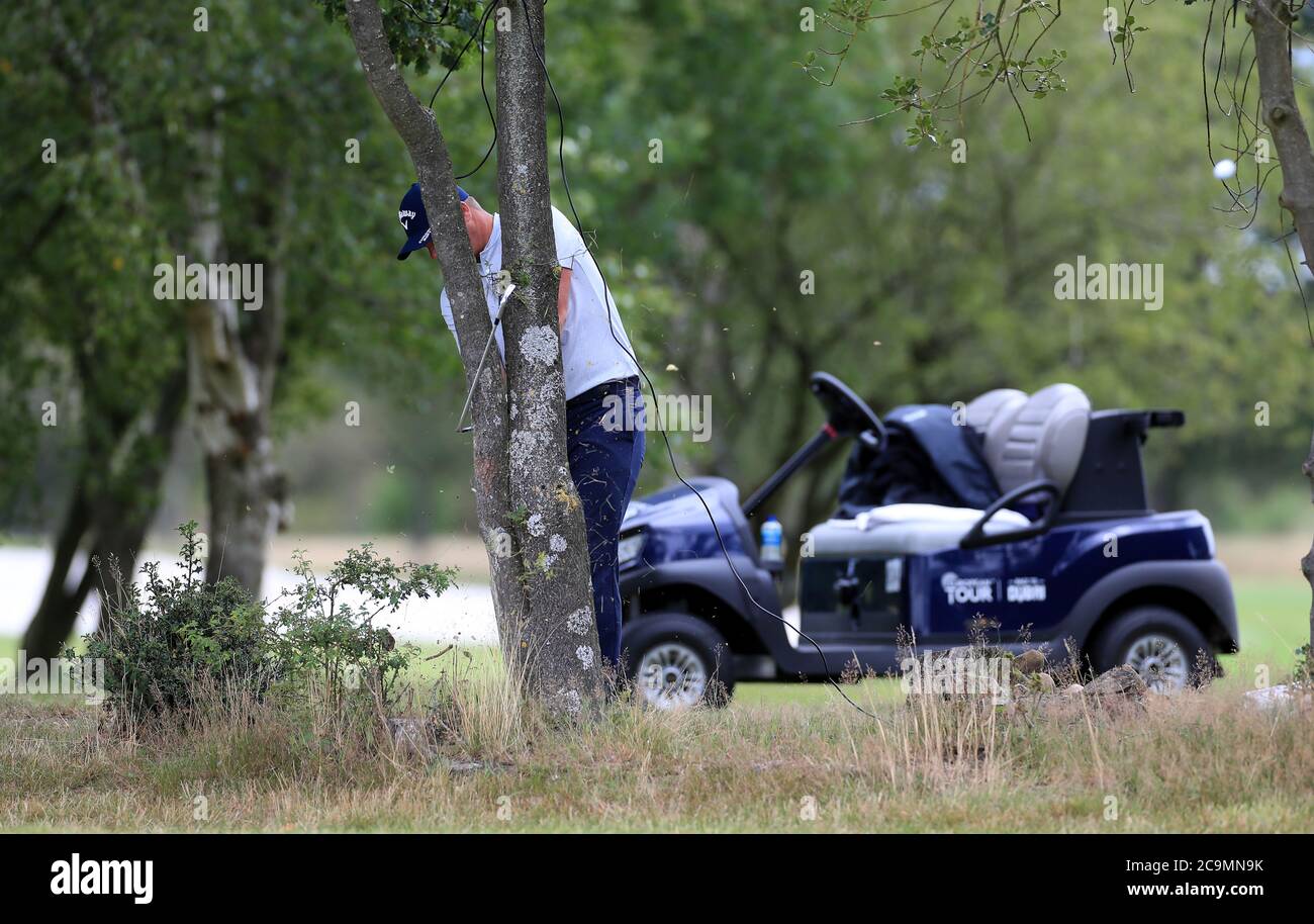 England's Callum Shinkwin breaks his club playing a shot around a tree ...