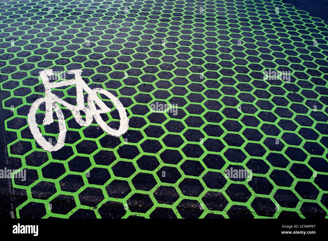 New funky green road markings to show bike paths crossing the road in ...