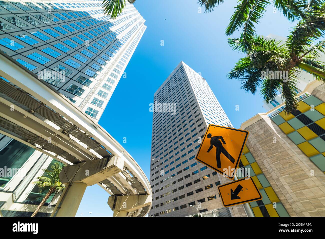 Pedestrian crossing sign by downtown Miami's skyscrapers. Southern ...