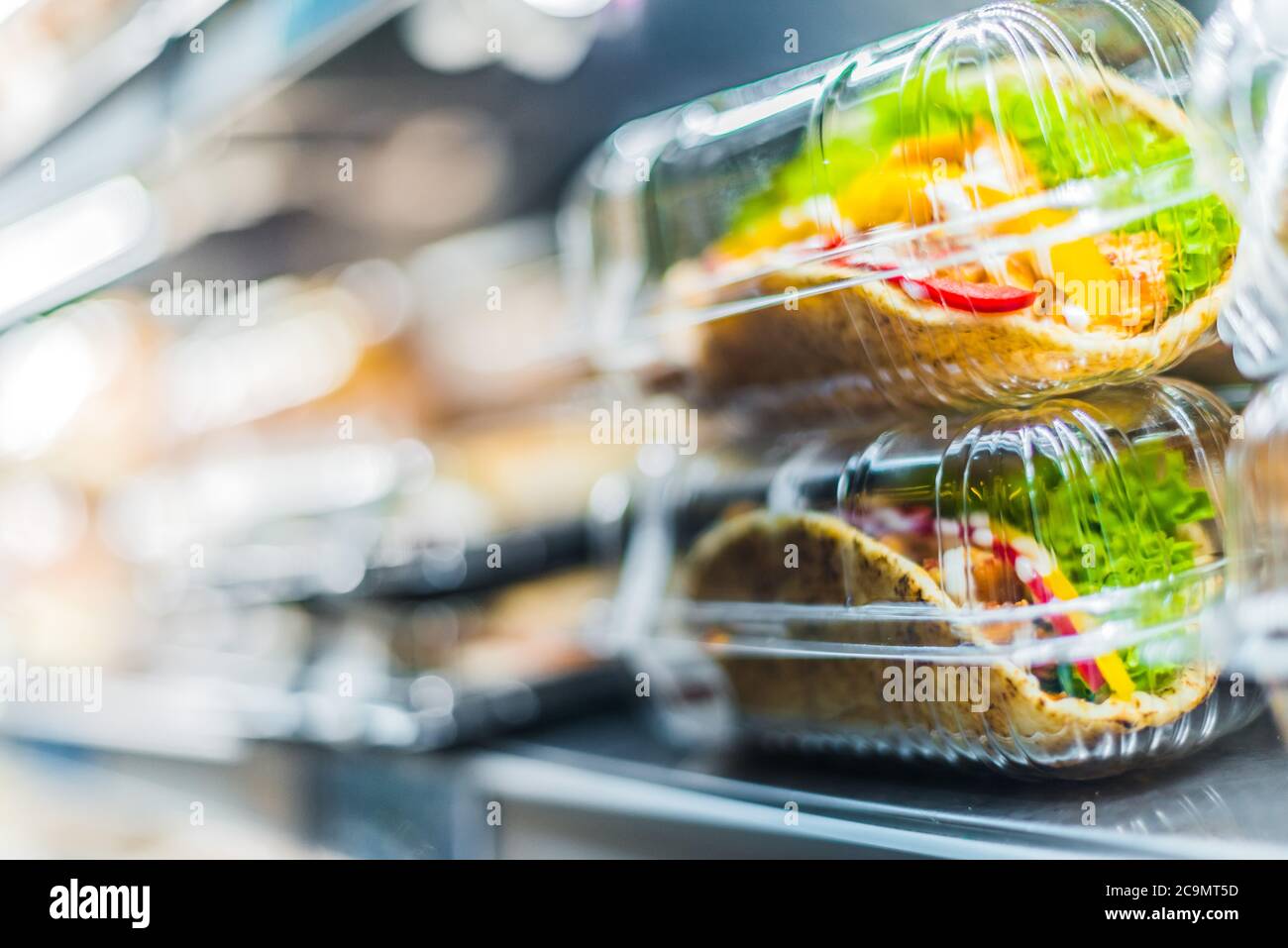 Chilli chicken with pita, pre-packaged sandwiches displayed in a ...