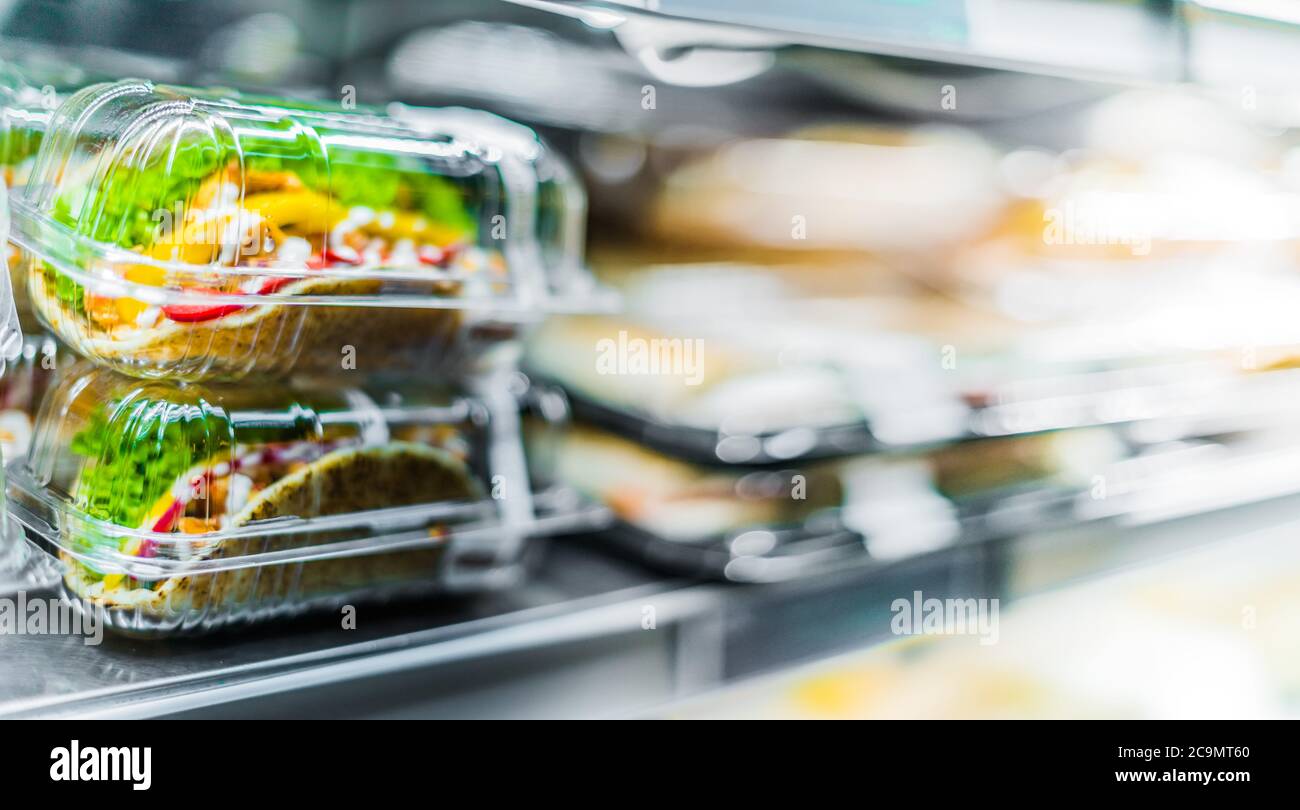 Chilli chicken with pita, pre-packaged sandwiches displayed in a ...