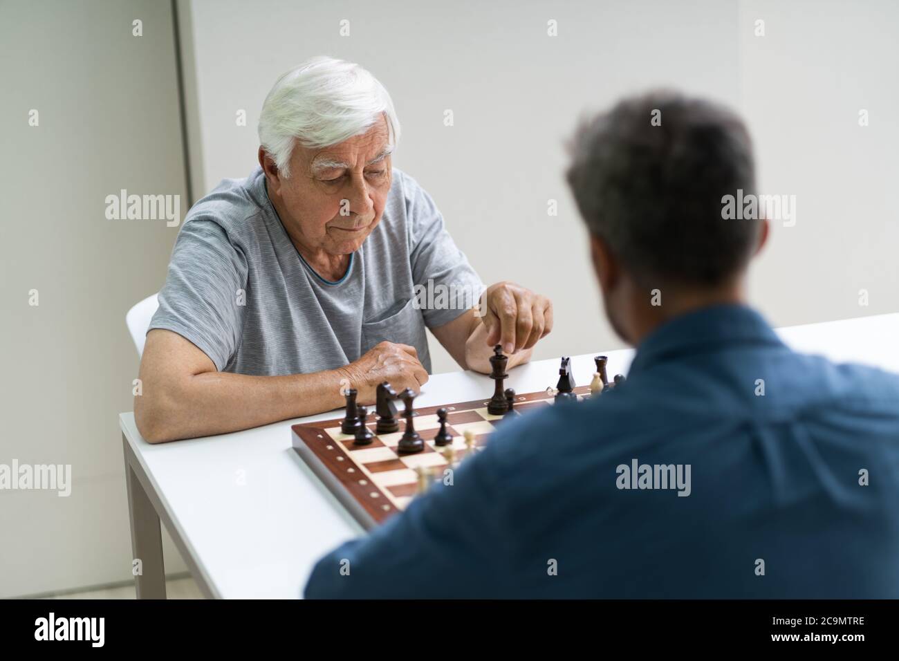 Elderly Senior Playing Chess Table Board Game Stock Photo - Alamy