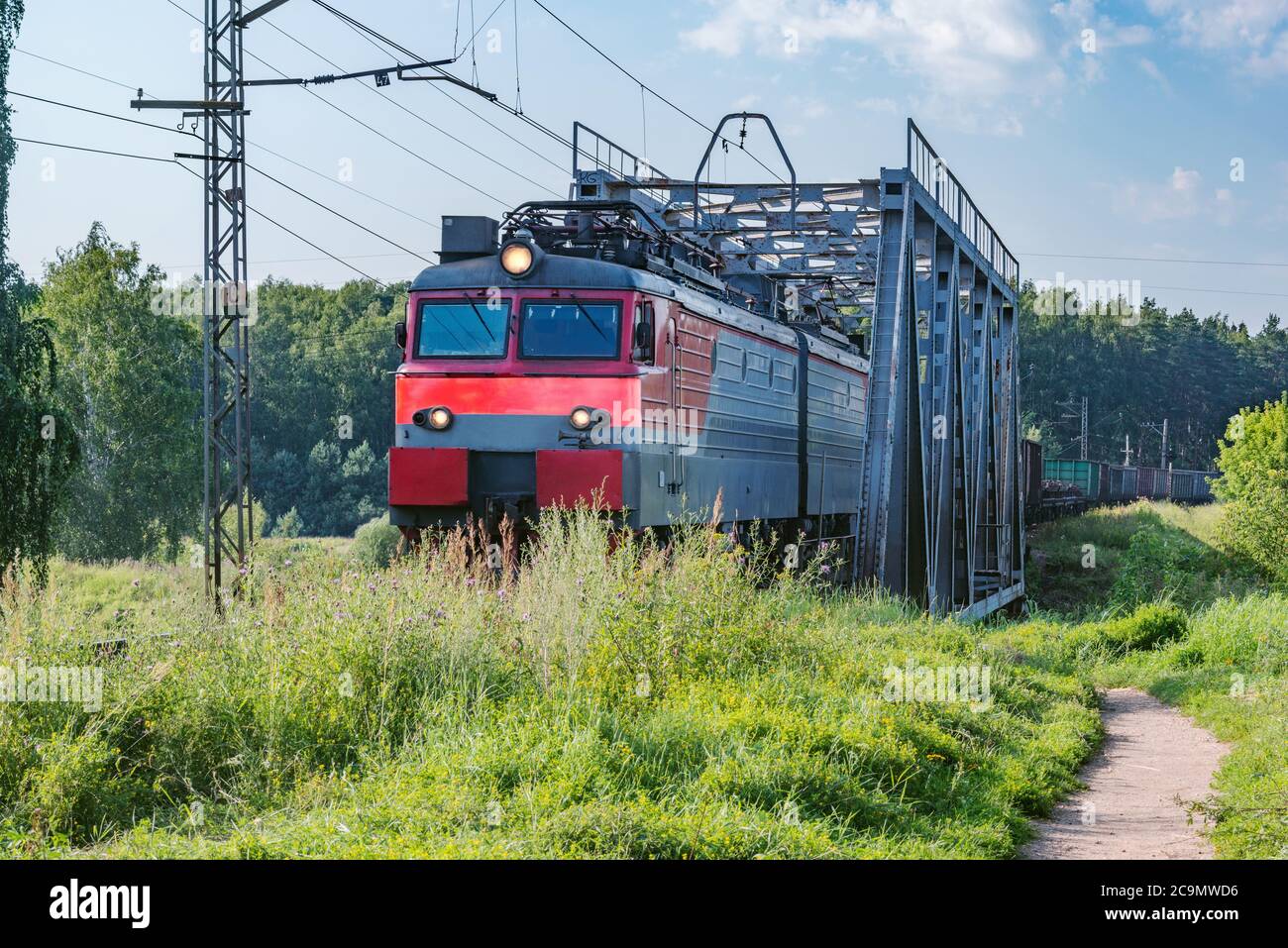 Long freight train moves through the bridge Stock Photo - Alamy