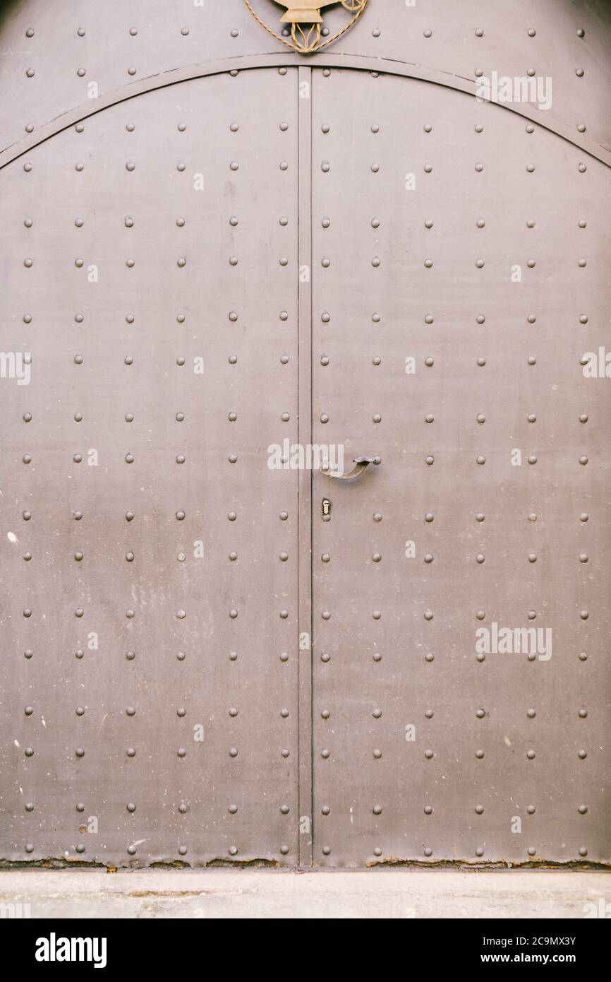 Close-up of a closed metal gate in color with rivets pattern Stock ...