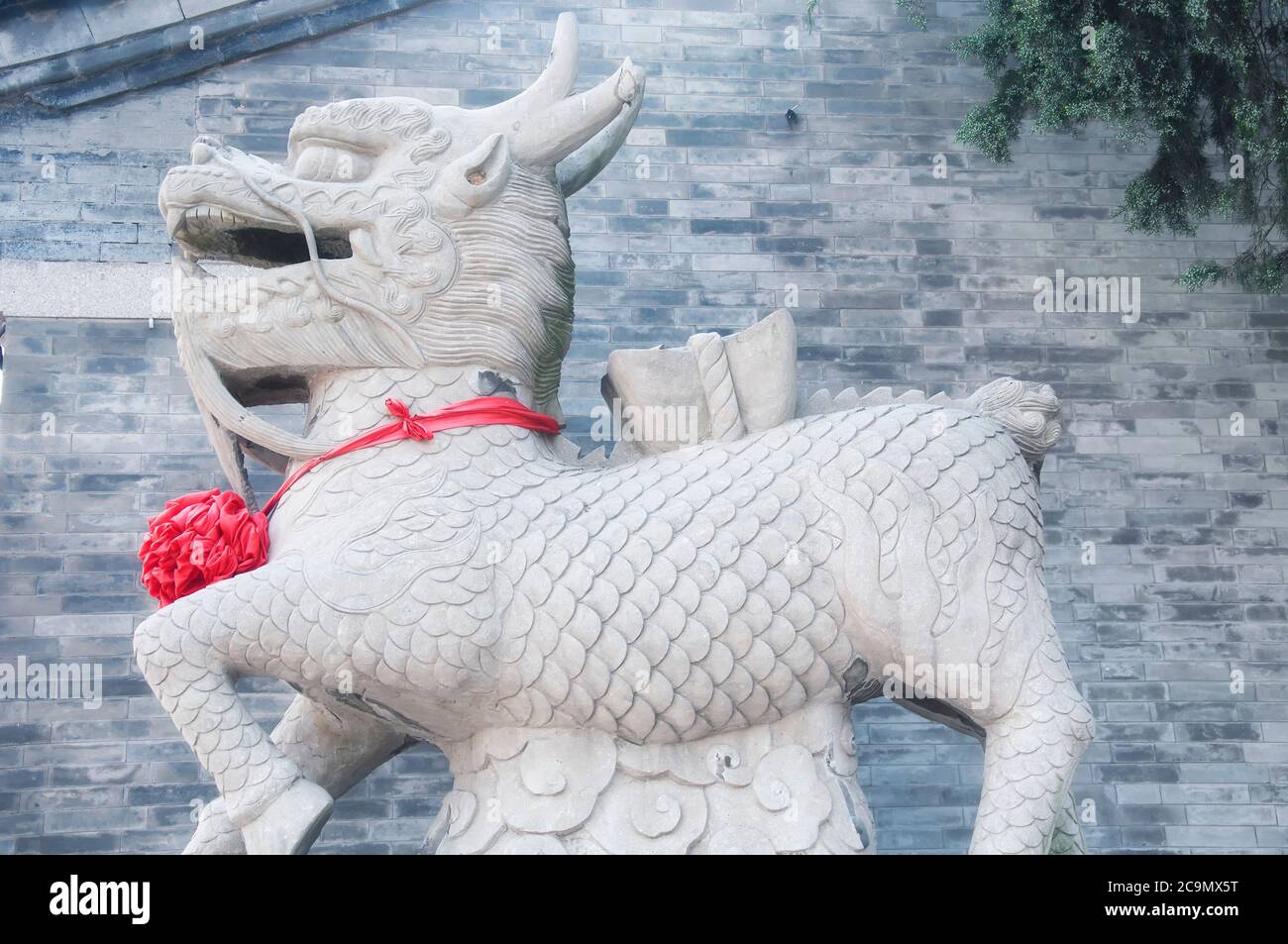 A mythical creature called a kylin with a red ribbon around its neck at ...
