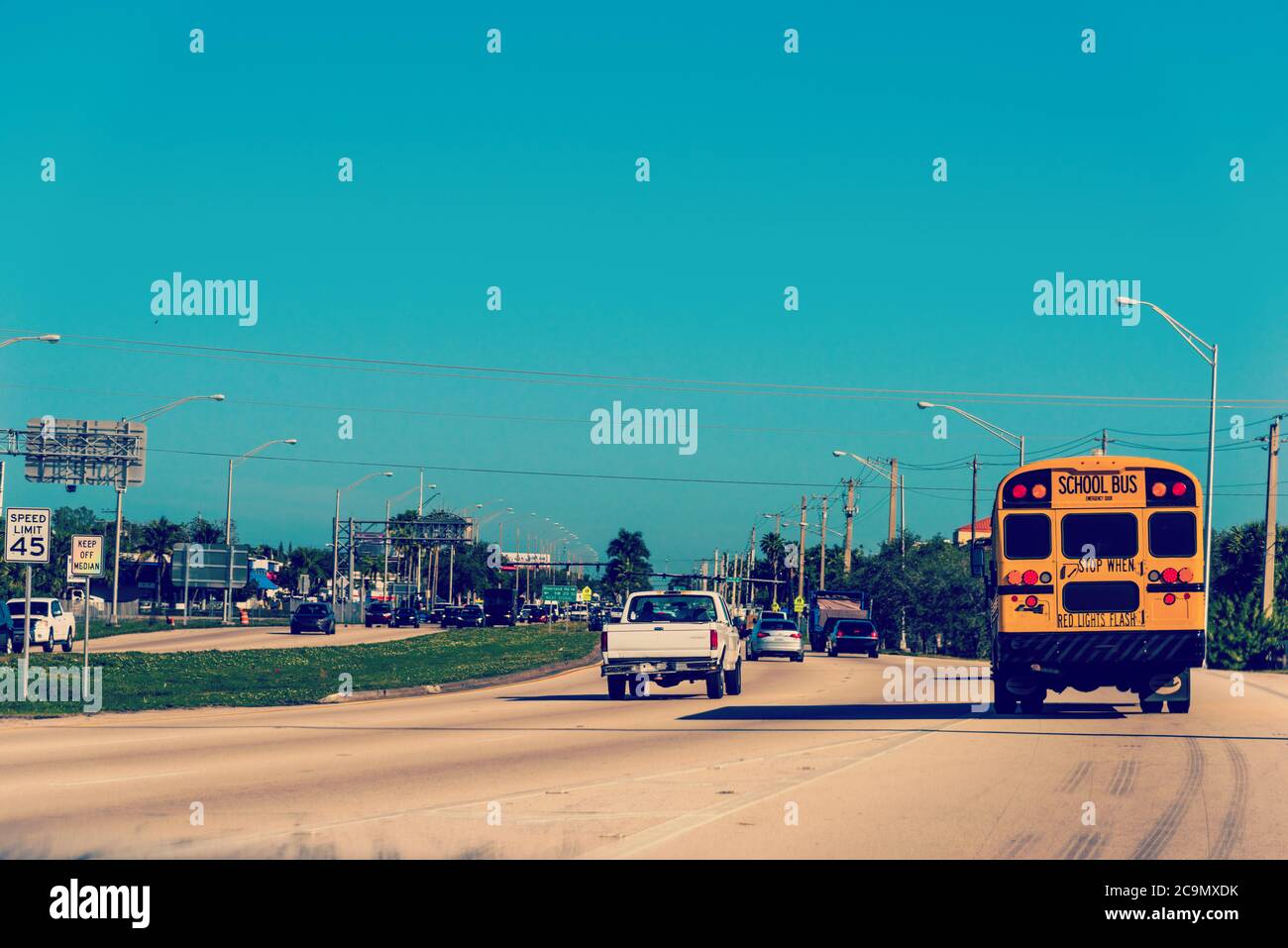 Classic school bus and old pickup truck on the highway in Miami, USA ...