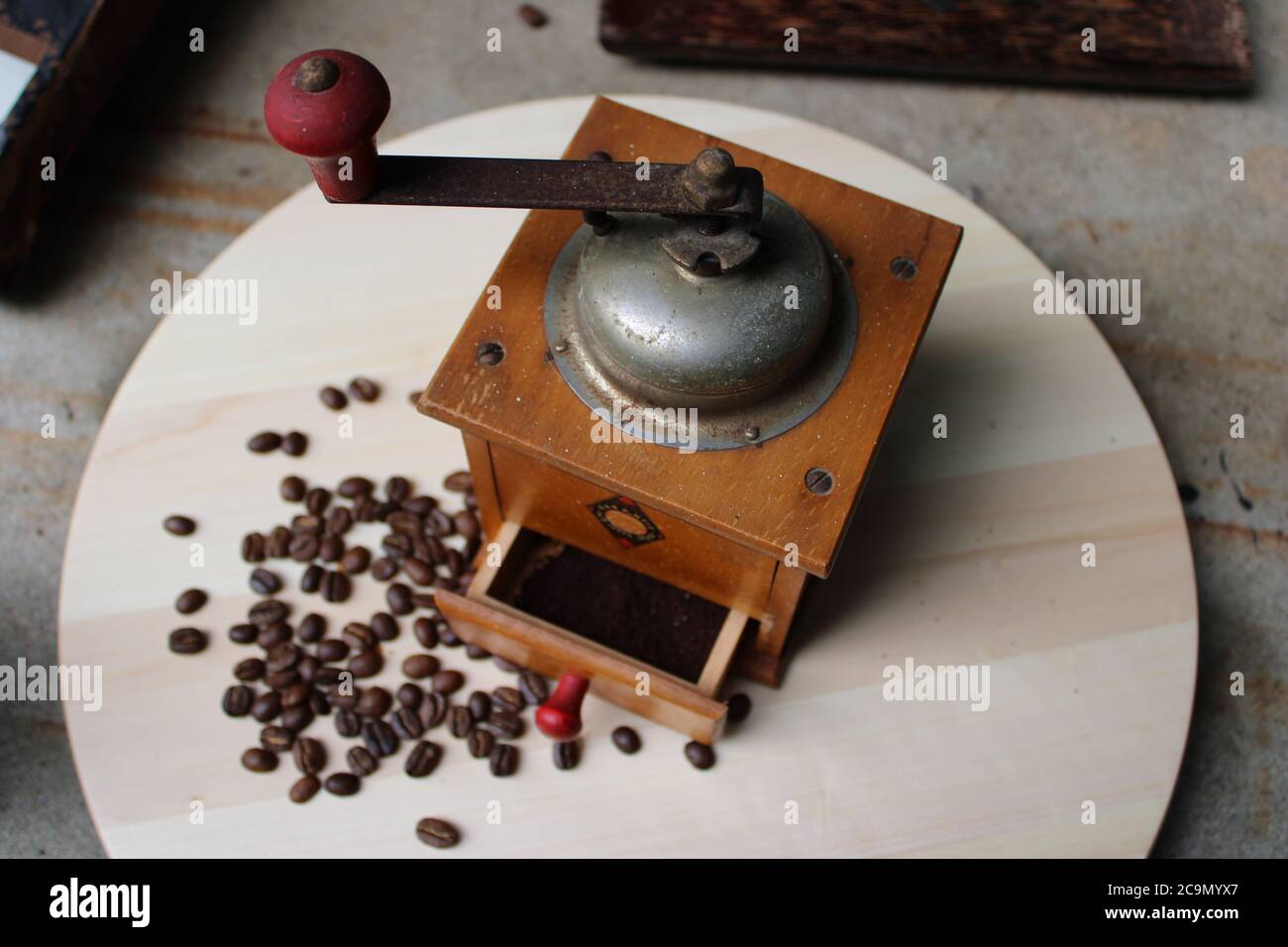 Antique German coffee grinder with grounds in its drawer, and beans ...