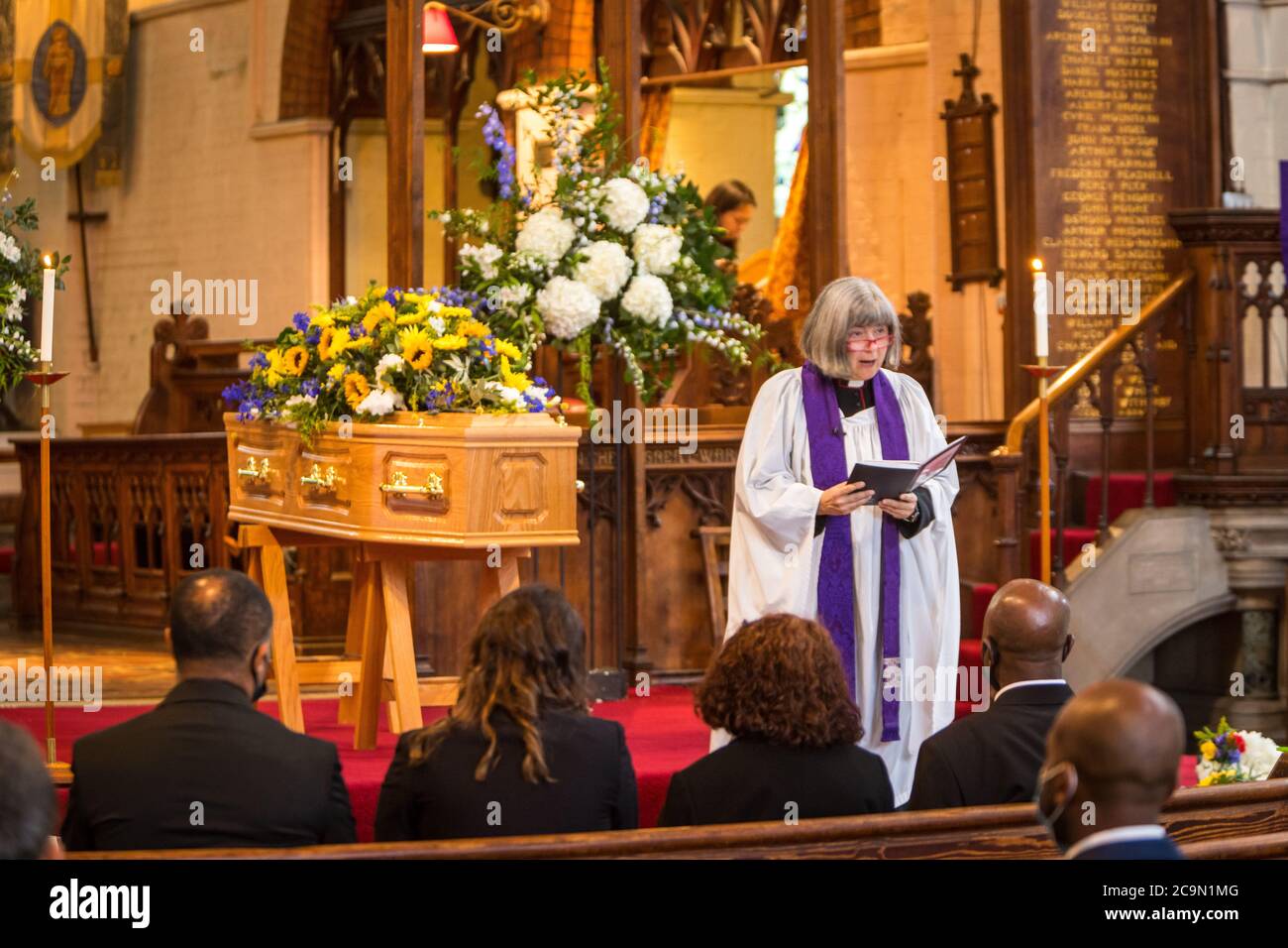 Female vicar officiating at a socially distanced funeral Stock Photo ...