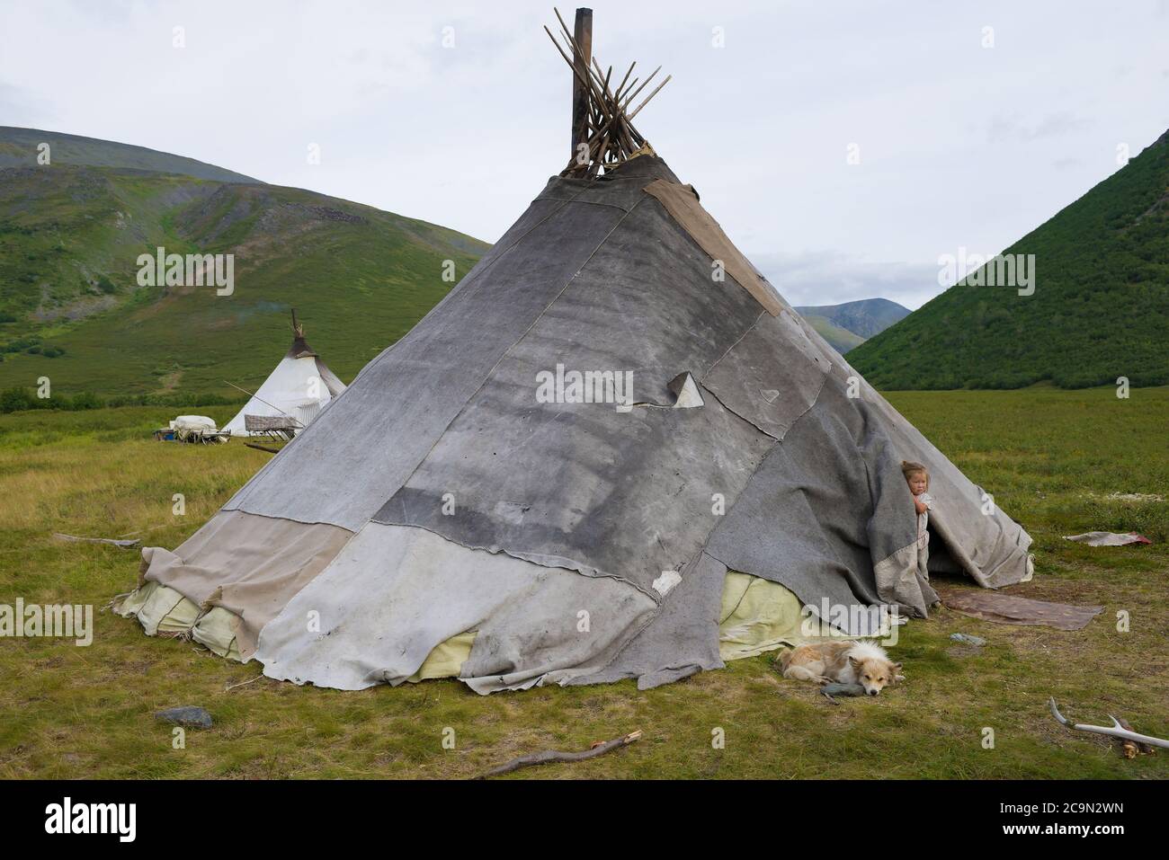 YAMAL, RUSSIA - AUGUST 23, 2018: A little girl looks out of the tent on ...