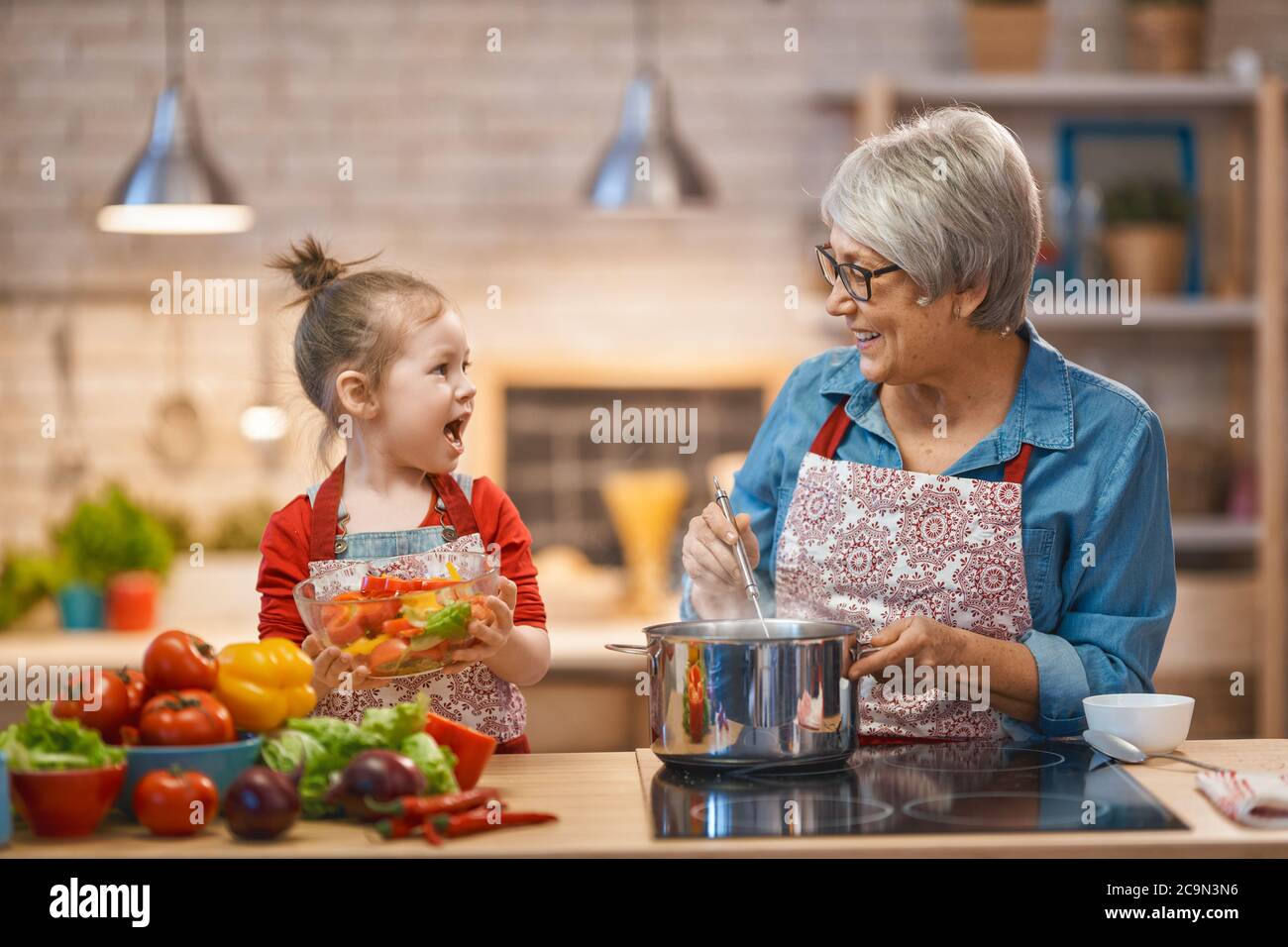 Healthy food at home. Happy family in the kitchen. Grandma and child ...