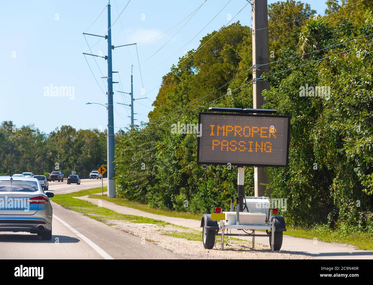 Improper passing written on a solar powered mobile road sign Stock ...