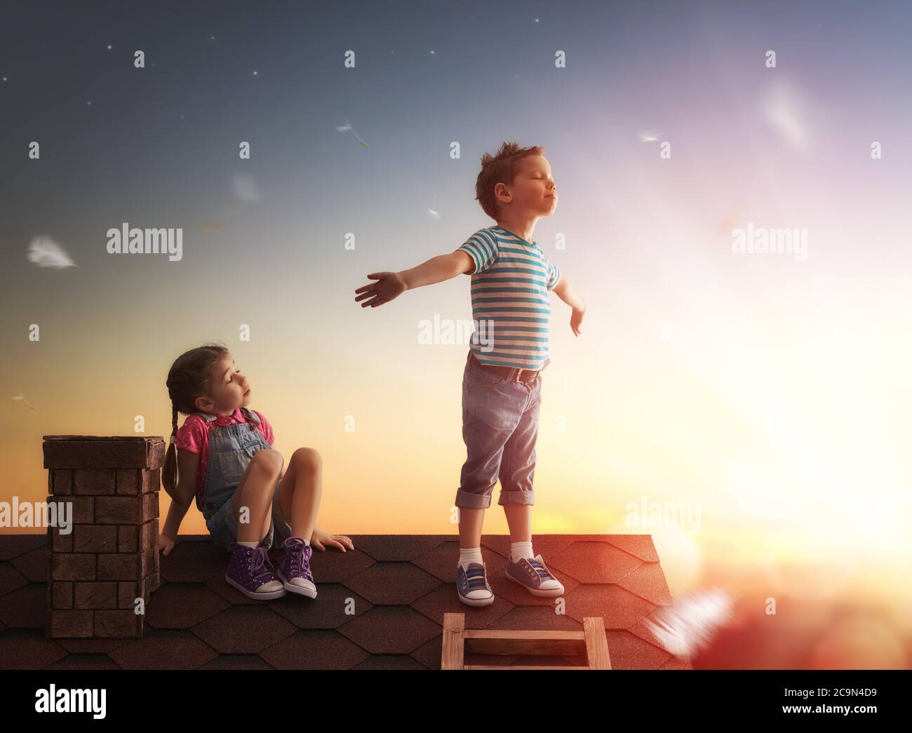 happy childhood! boy and girl playing on the roof Stock Photo - Alamy