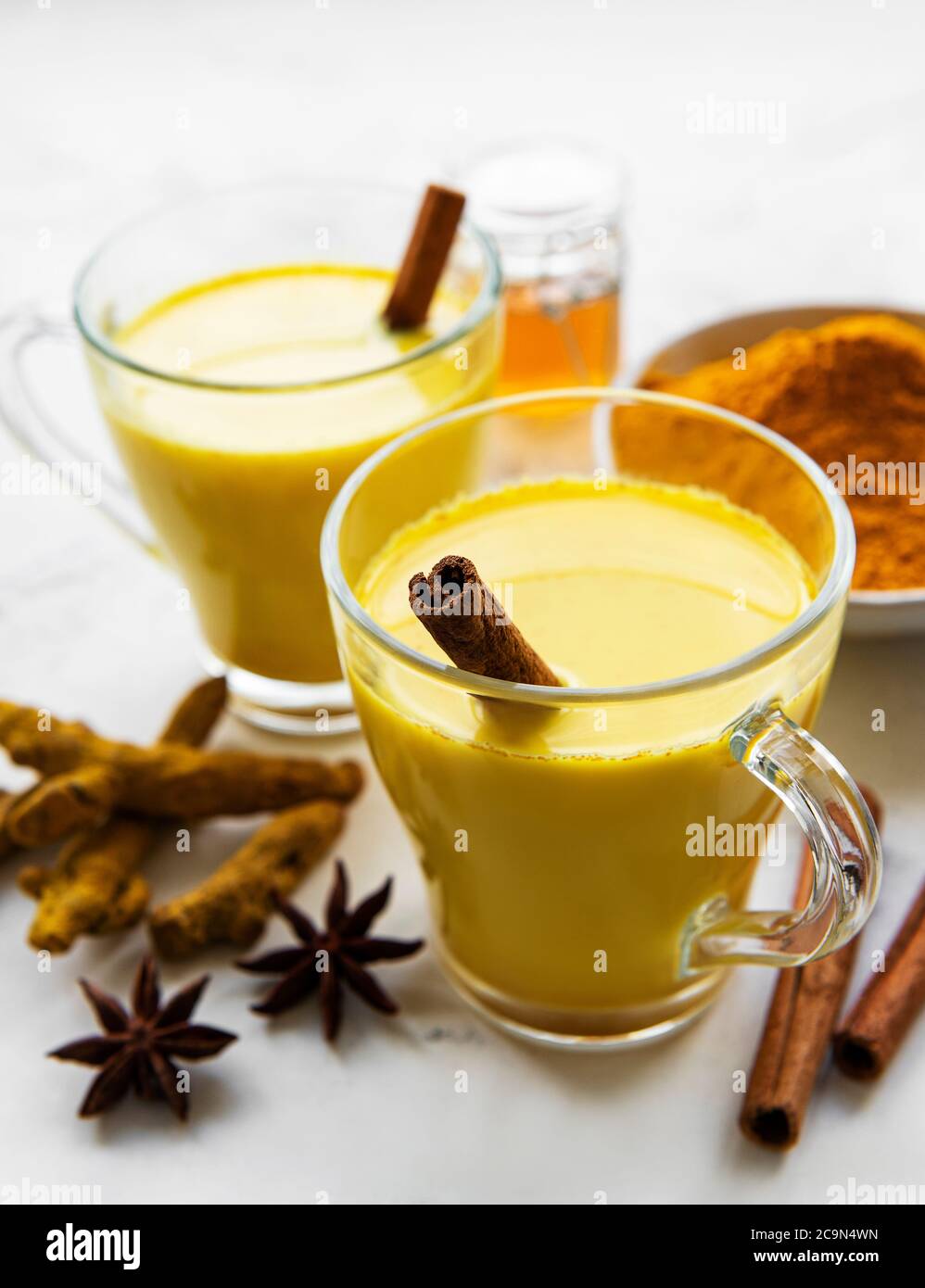 Yellow turmeric latte drink. Golden milk with cinnamon, turmeric ...