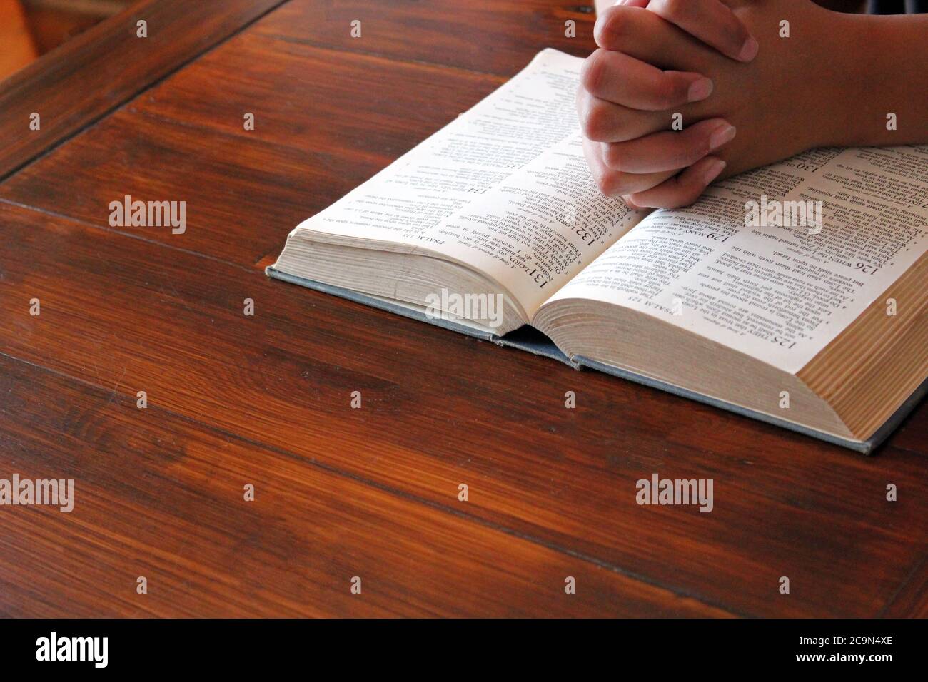 praying hands with bible and rosary beads with background with copy ...