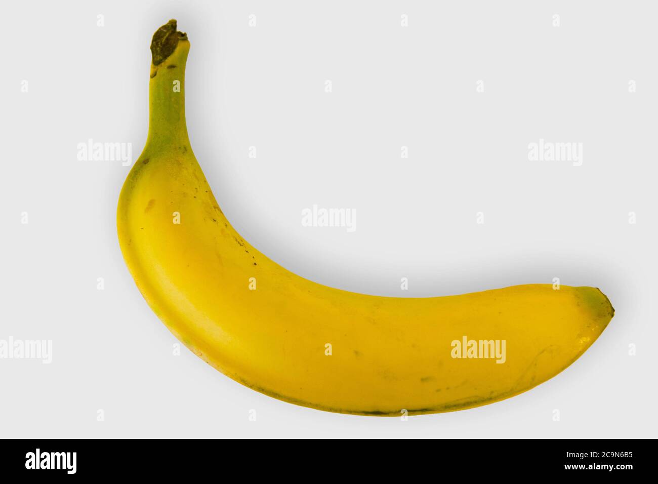 one yellow banana on white background Stock Photo - Alamy