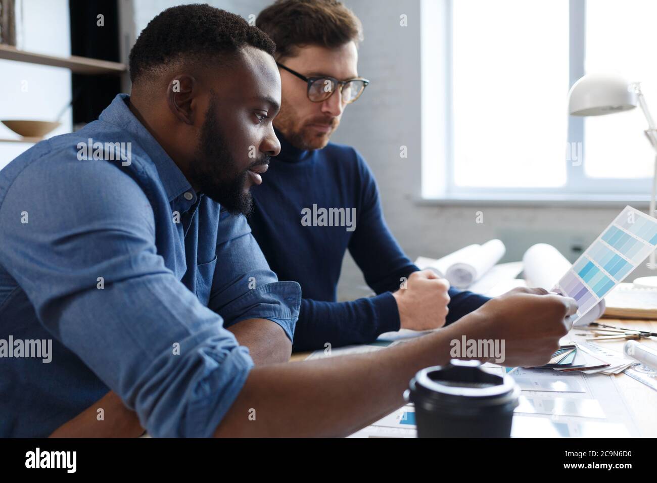 Multiracial engineer team working in office with color palette ...