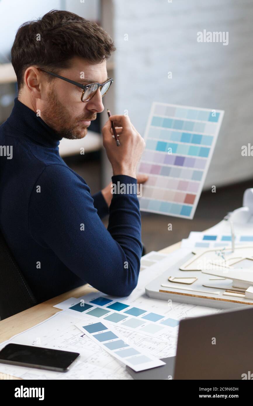Architect working in office with color palette. Engineer select colors ...