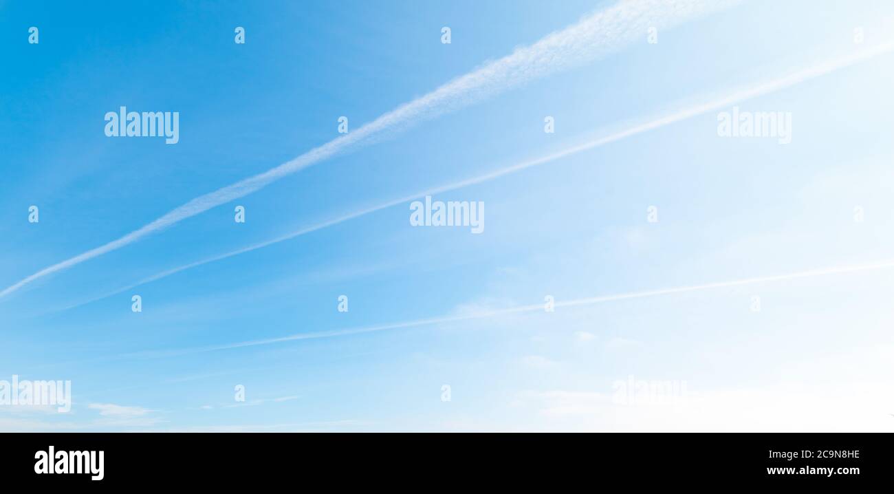 Airplane contrails in the blue sky Stock Photo - Alamy