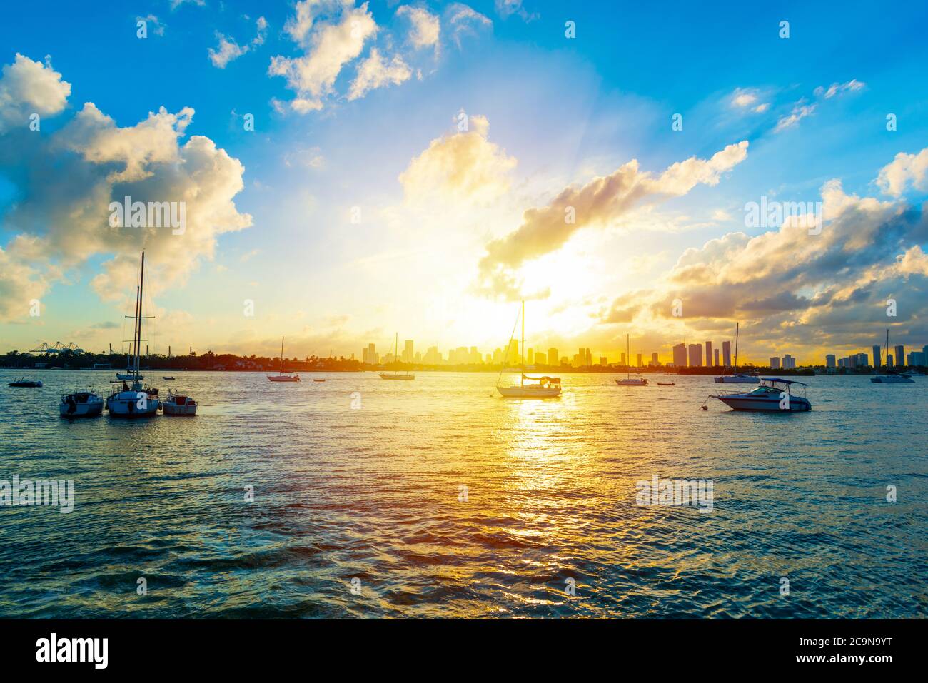 Sun shining over Miami Beach bayfront at sunset, USA Stock Photo - Alamy