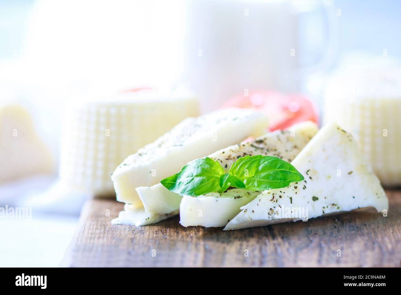 Homemade cheese halloumi with herbs on a light background. Copy space ...