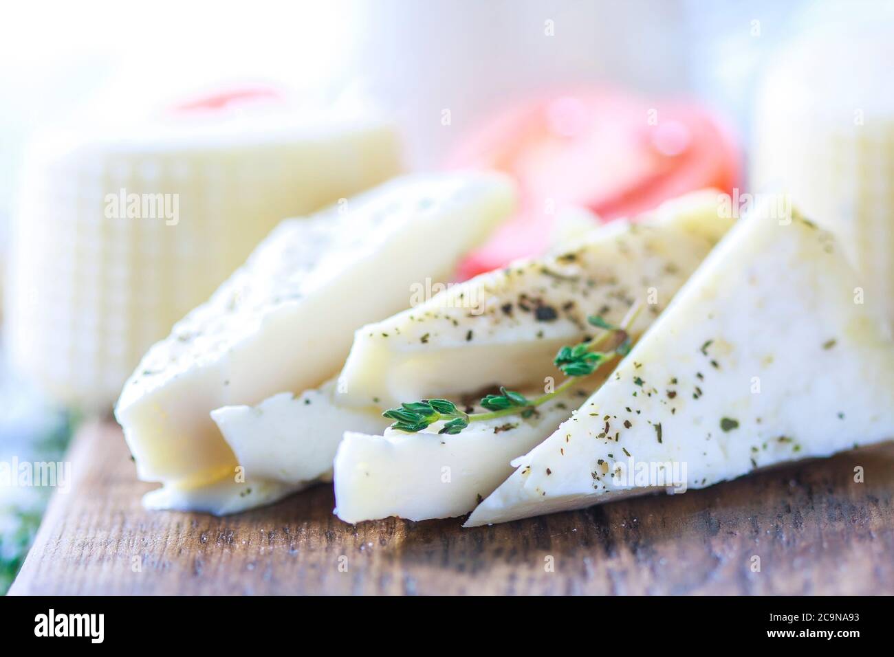 Homemade cheese halloumi with herbs on a light background. Copy space ...