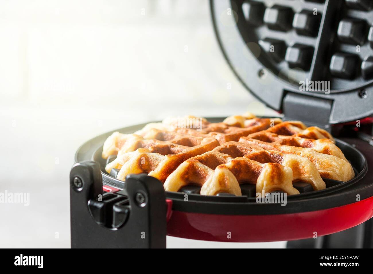 The process of making homemade waffles. Freshly baked waffles in a ...