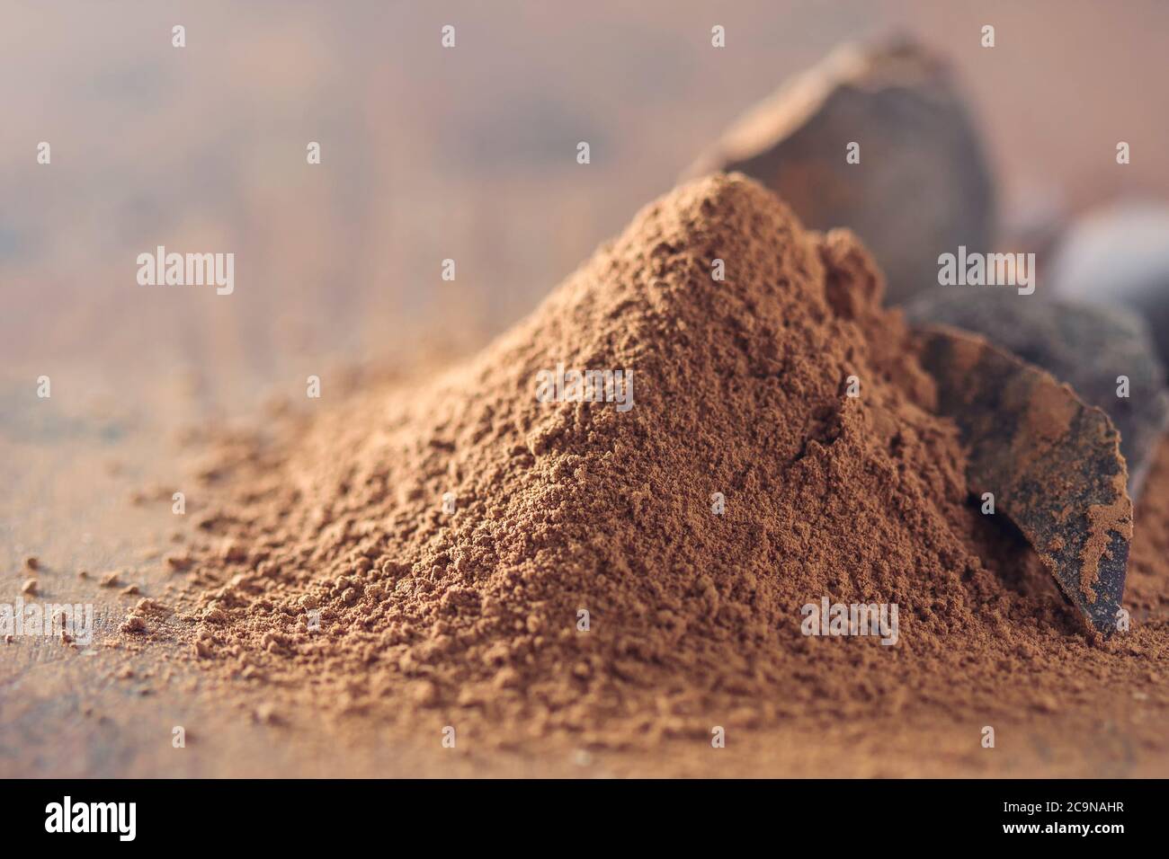dark chocolate, cocoa solids and cocoa powder over wooden background ...