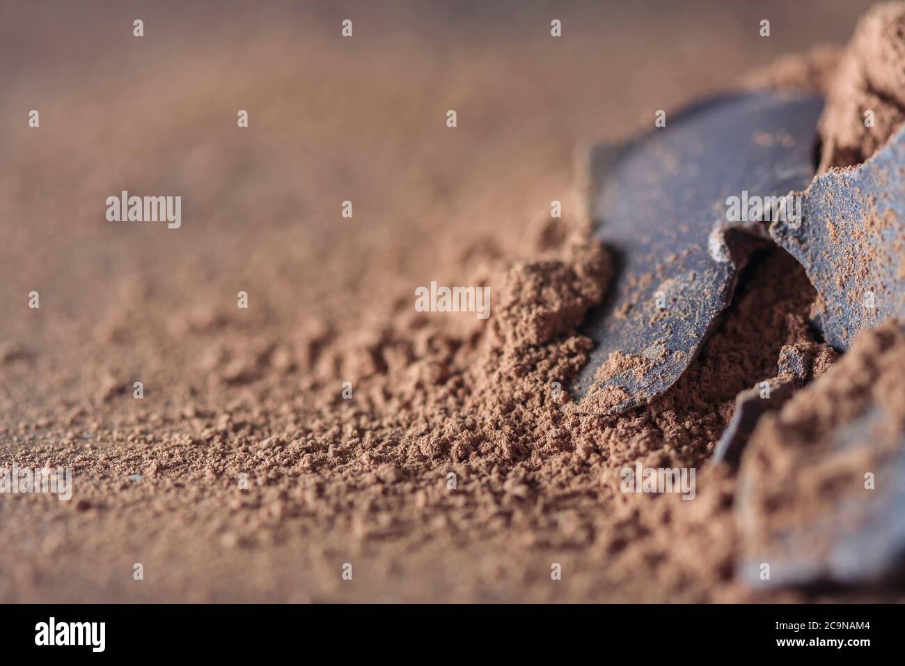 dark chocolate, cocoa solids and cocoa powder over wooden background ...