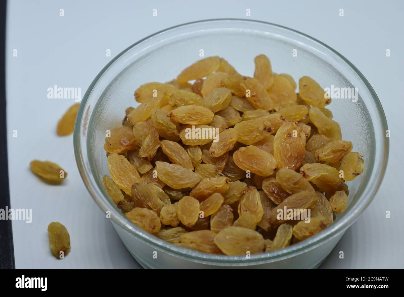 Dried grapes are yellow isolated on white background Stock Photo - Alamy