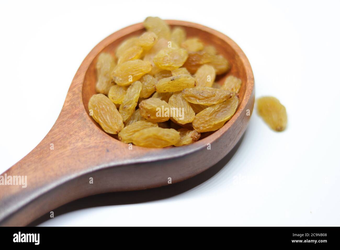 Dried grapes are yellow isolated on white background Stock Photo - Alamy