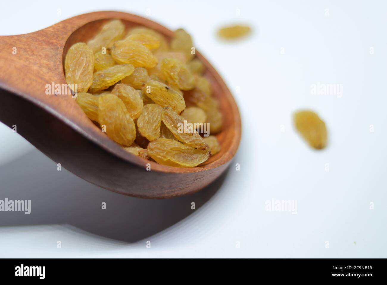 Dried grapes are yellow isolated on white background Stock Photo - Alamy