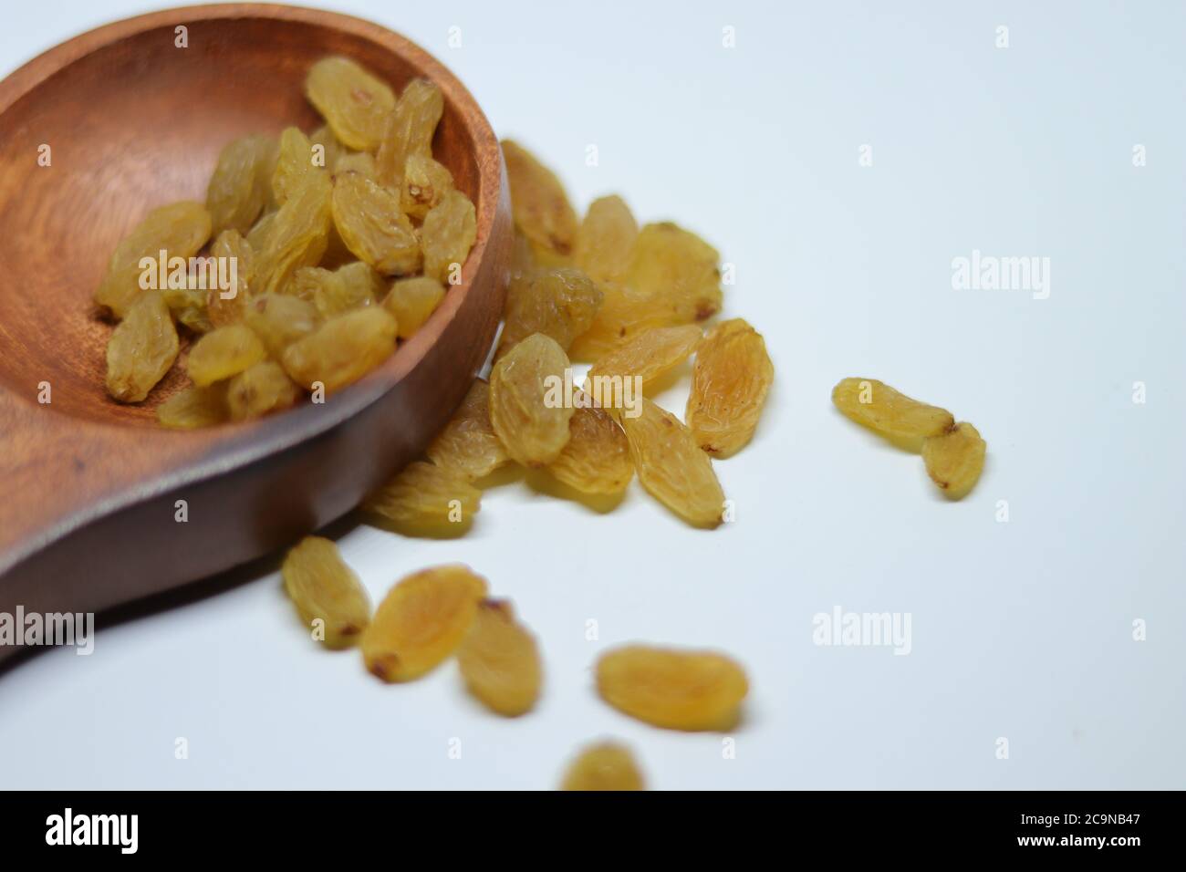 Dried grapes are yellow isolated on white background Stock Photo - Alamy