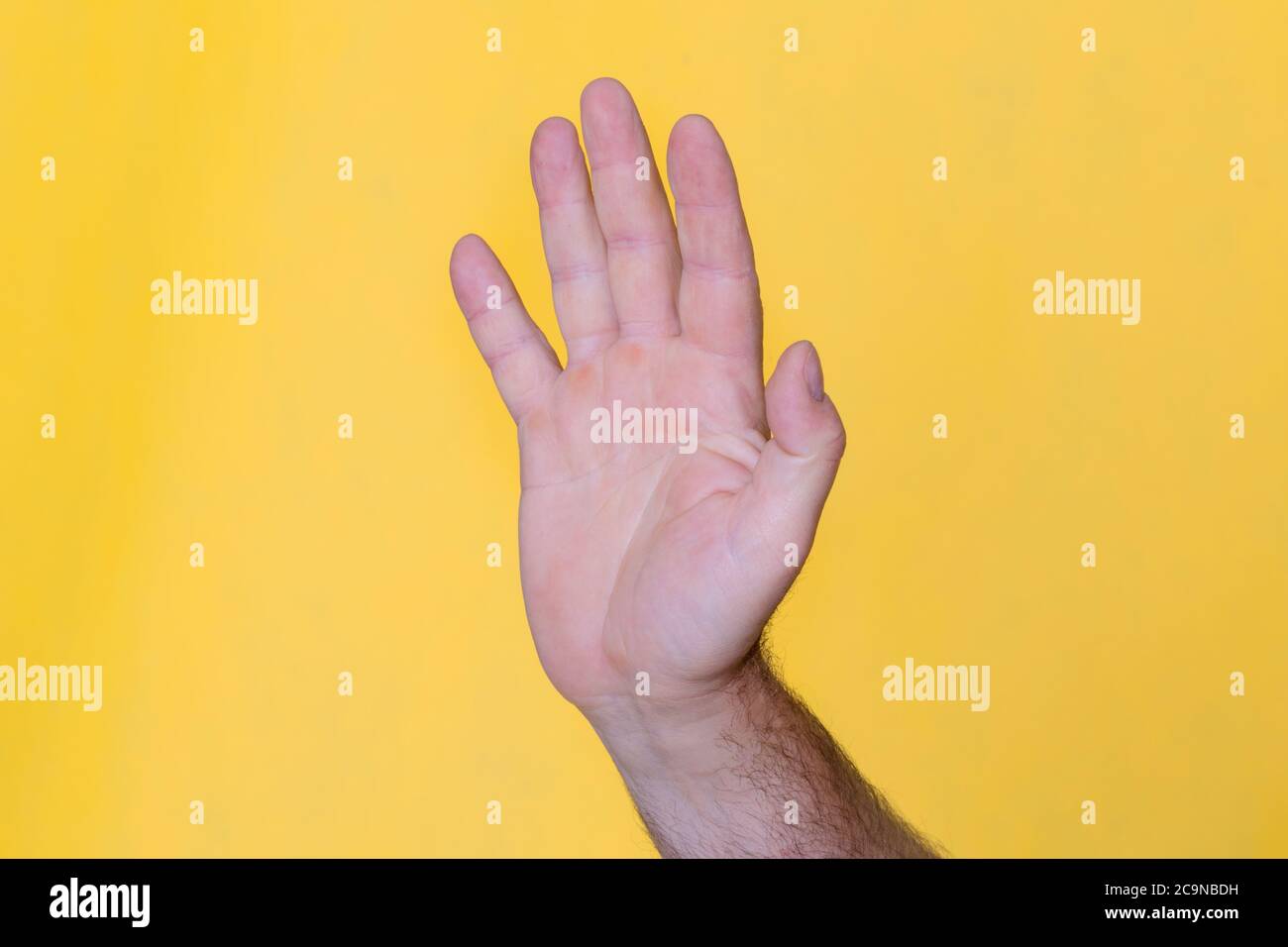 Arm with fingers showing stop sign hi-res stock photography and images ...