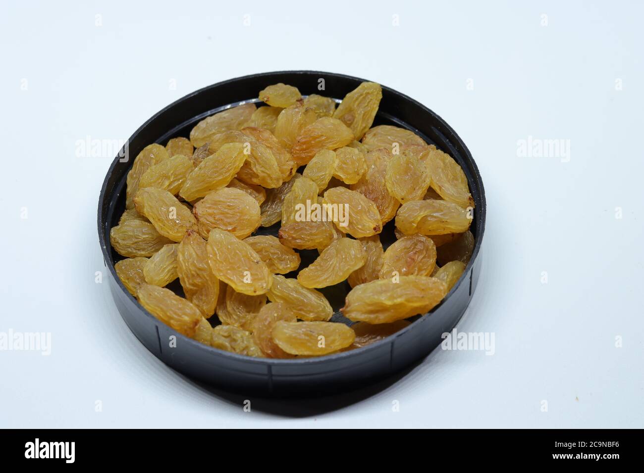 Dried grapes are yellow isolated on white background Stock Photo - Alamy