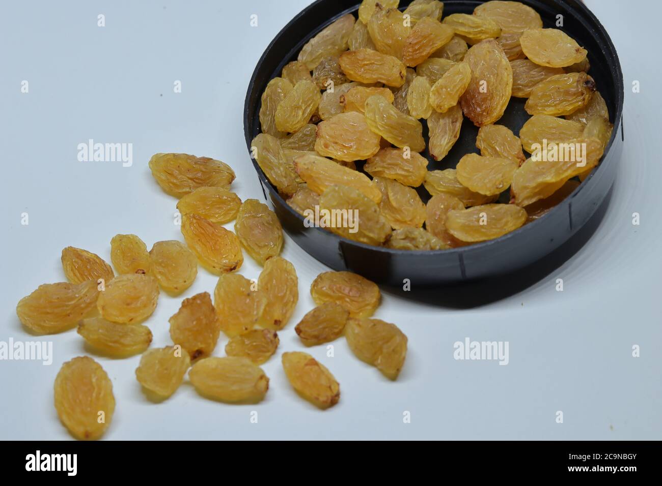 Dried grapes are yellow isolated on white background Stock Photo - Alamy
