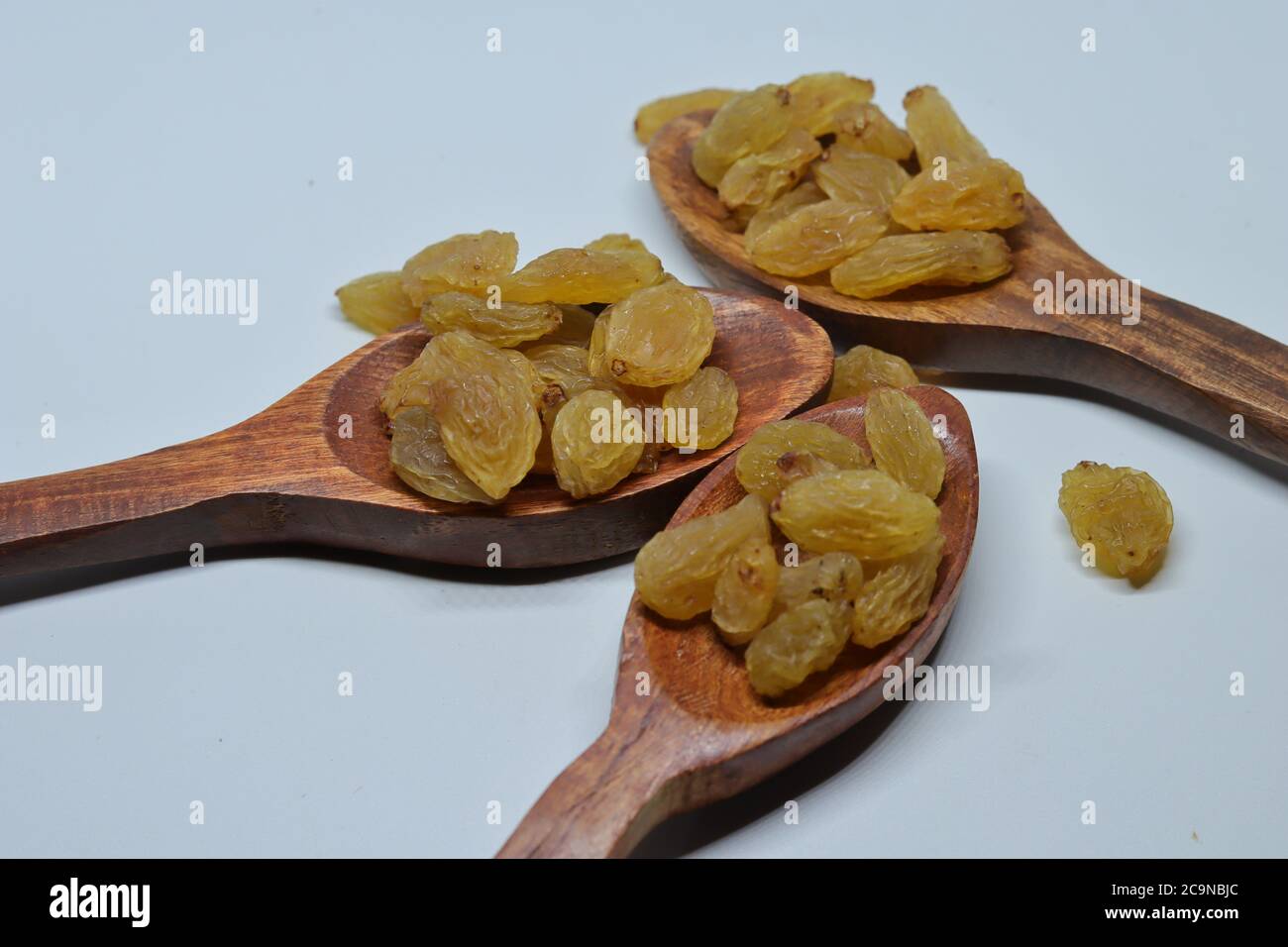 Dried grapes are yellow isolated on white background Stock Photo - Alamy