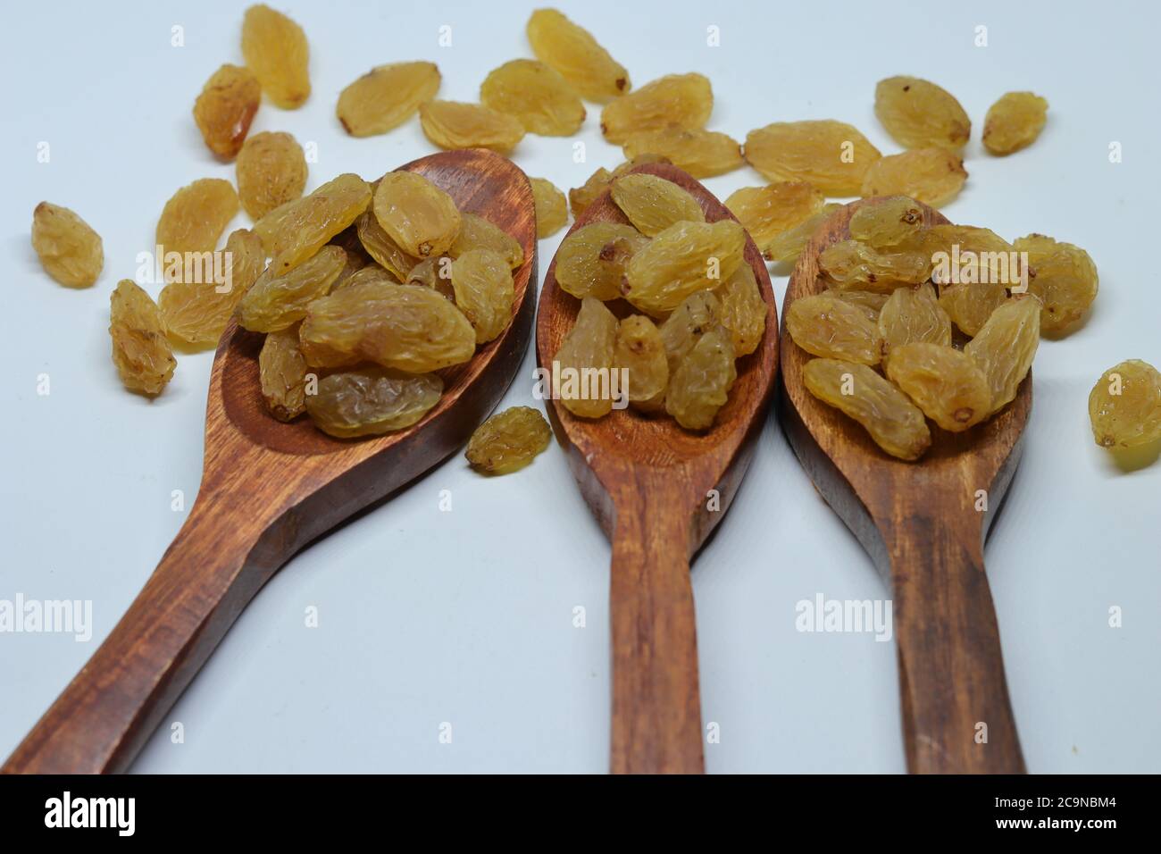 Dried grapes are yellow isolated on white background Stock Photo - Alamy