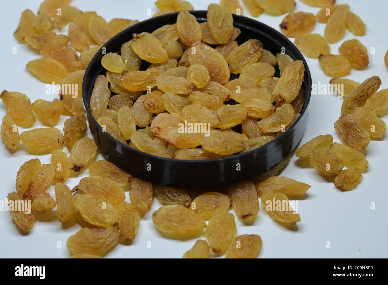 Dried grapes are yellow isolated on white background Stock Photo - Alamy