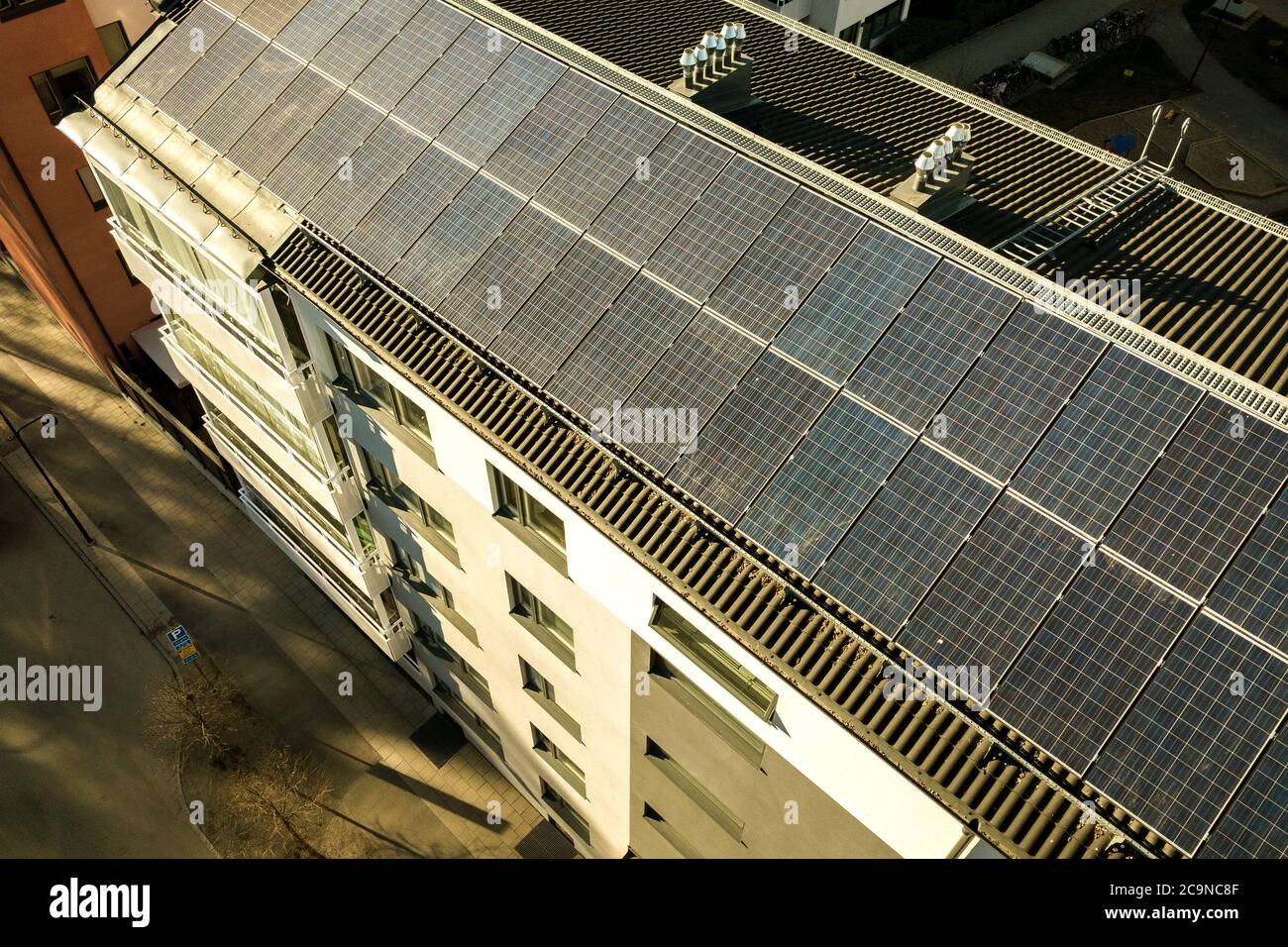 Aerial view of solar photovoltaic panels on a roof top of residential ...