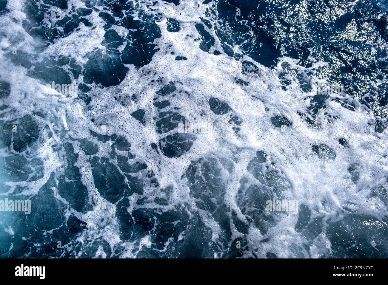 Top down aerial view of sea water surface. White foam waves texture as ...