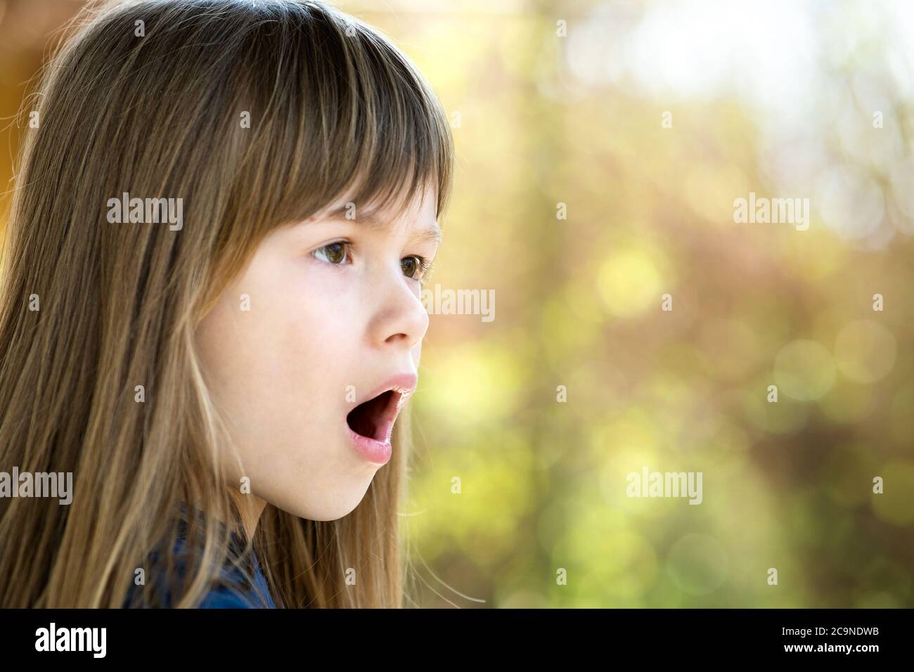 Portrait of surprised child girl outdoors in summer. Shocked female kid ...