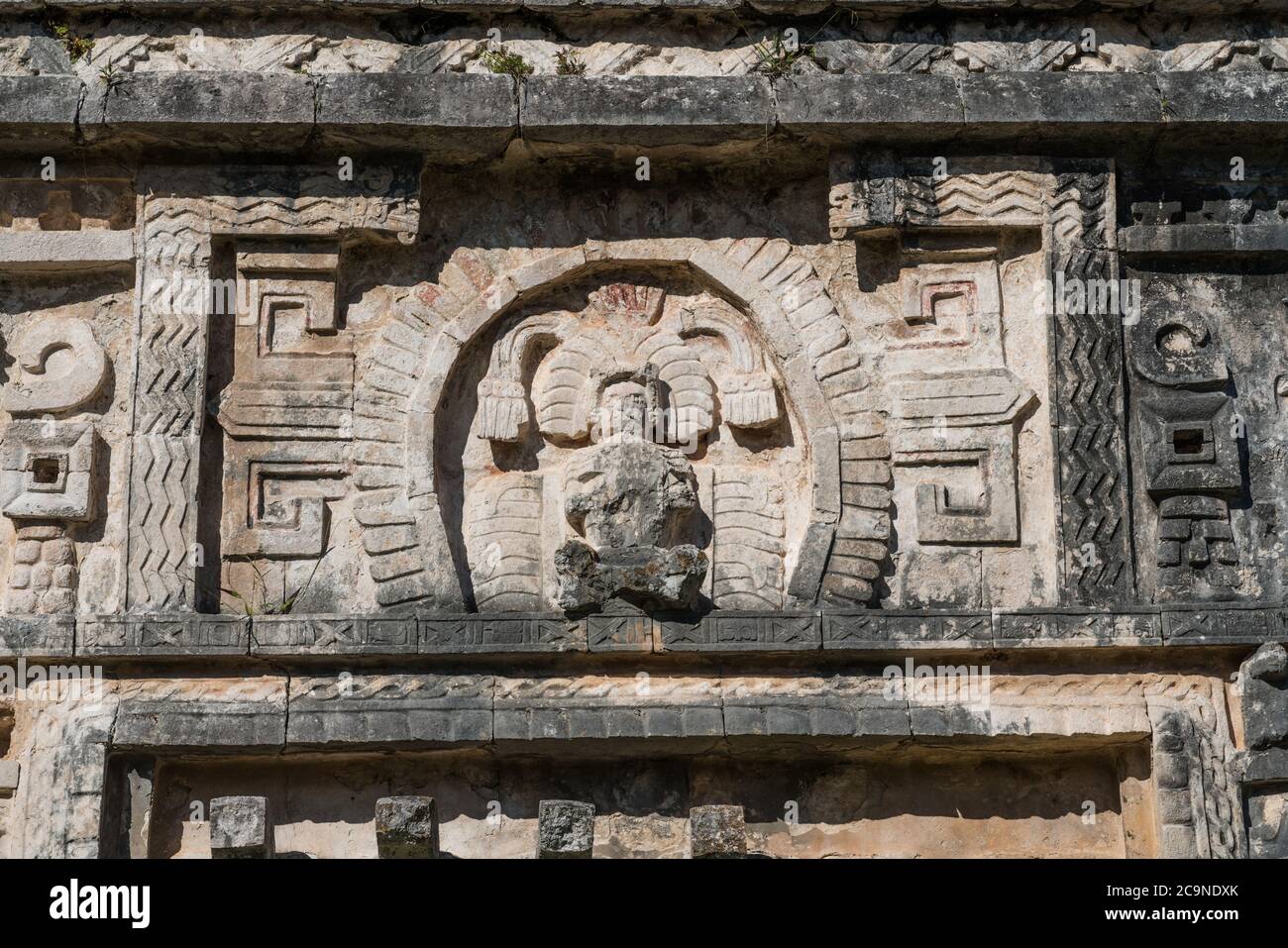 A carved stone bas relief figure on the facade of the Nunnery Complex ...